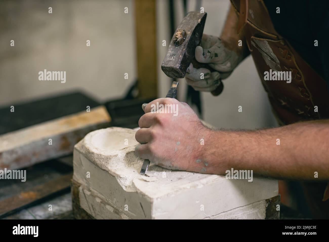 Man sculptor creates sculpt bust gypsum human woman sculpture with ...