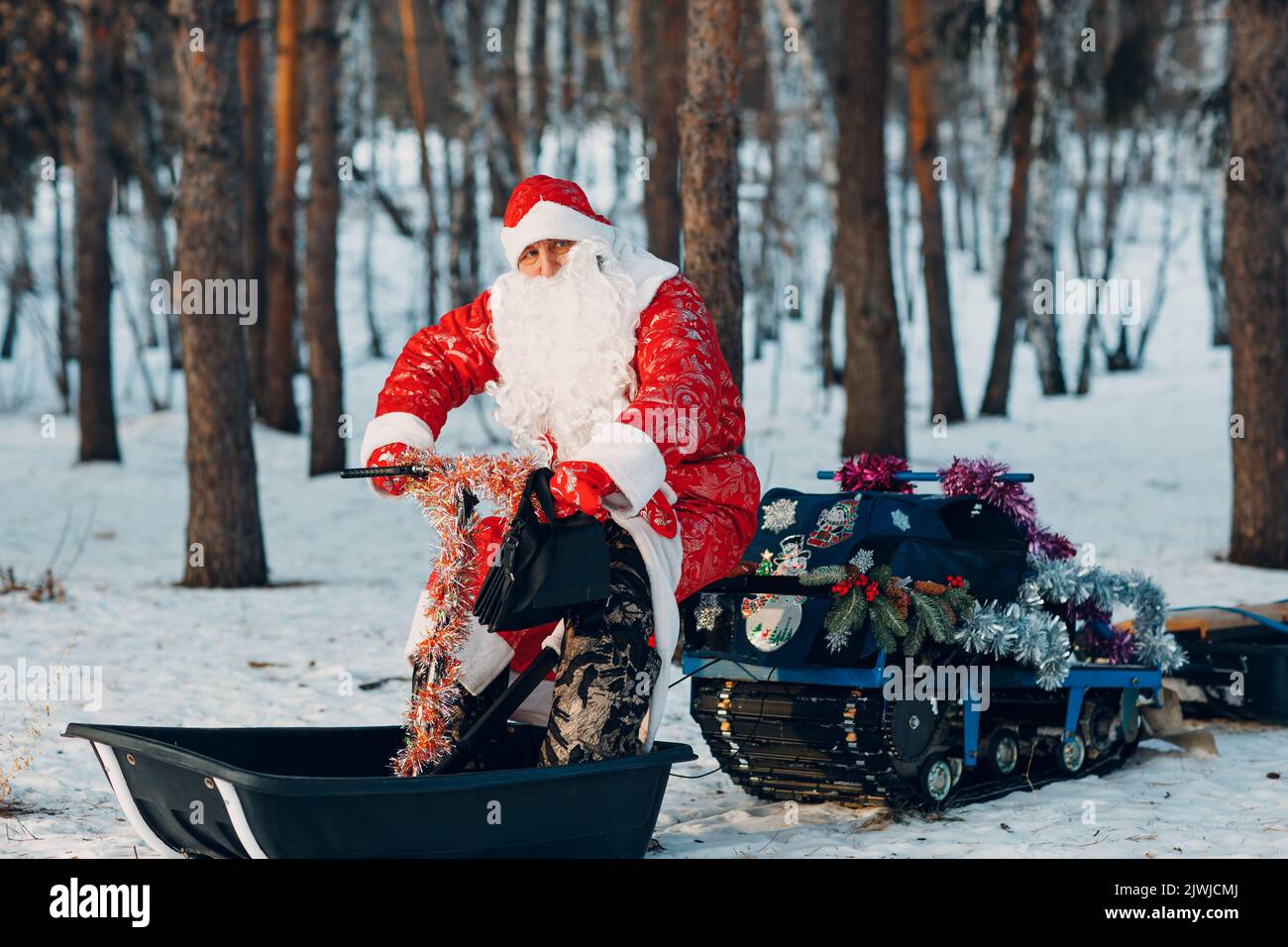 Santa claus riding snowmobile in the winter forest Stock Photo - Alamy