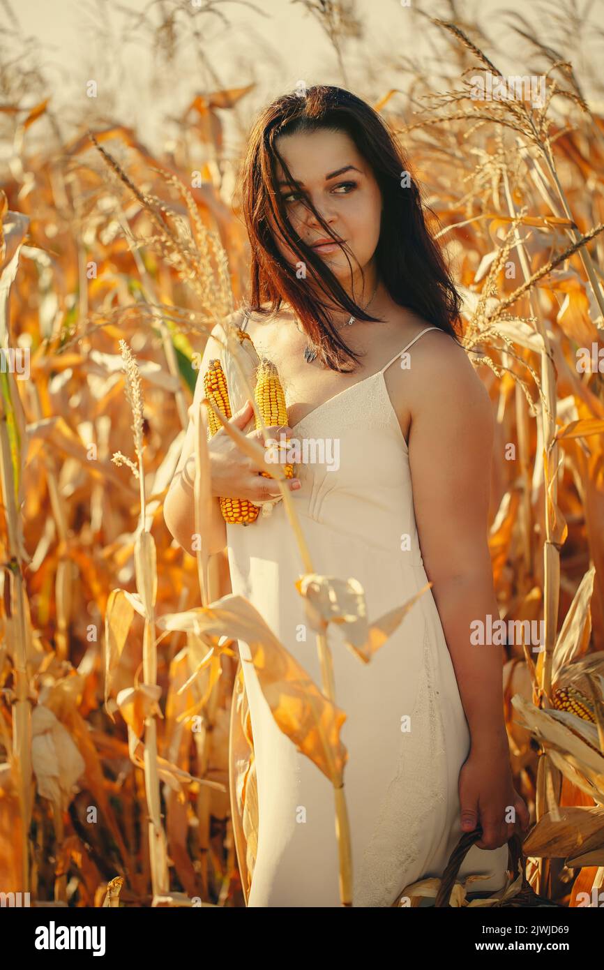 Beautiful woman holding corn hi-res stock photography and images - Alamy