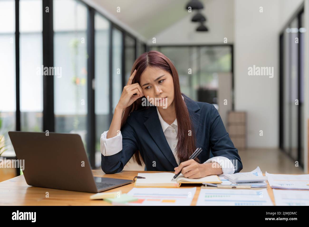 Young asian Woman Office Worker Uses Laptop, Feels Sudden Burst of Pain ...