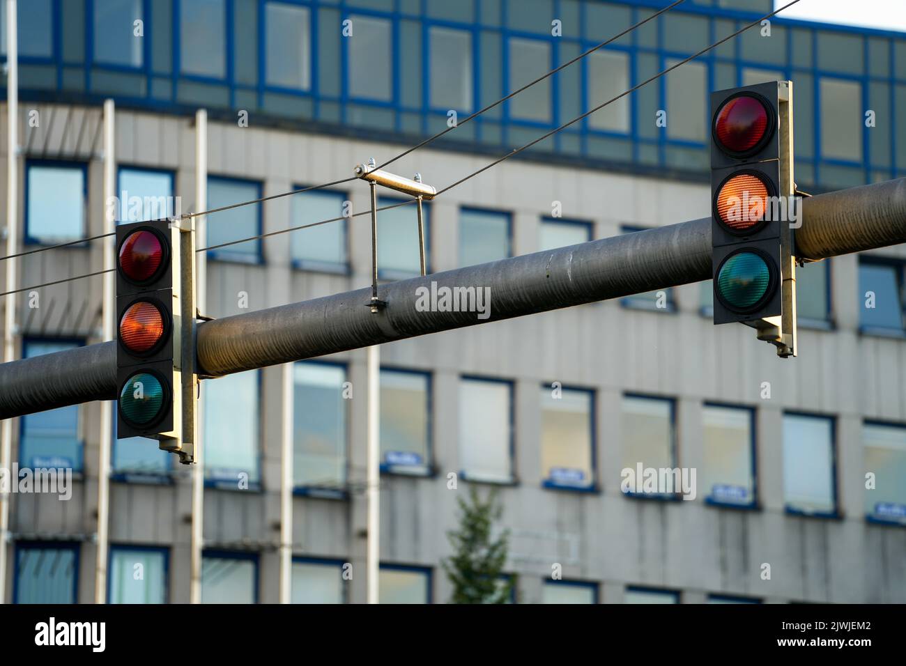 The traffic lights with yellow light on horizontal pole Stock Photo - Alamy