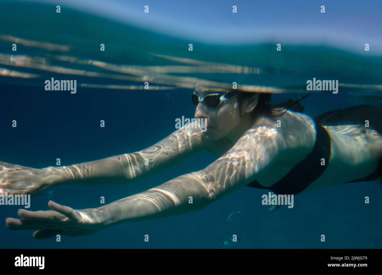 2022 - AUGUST - ITALY - Professional swimmer in rough ocean swimming ...