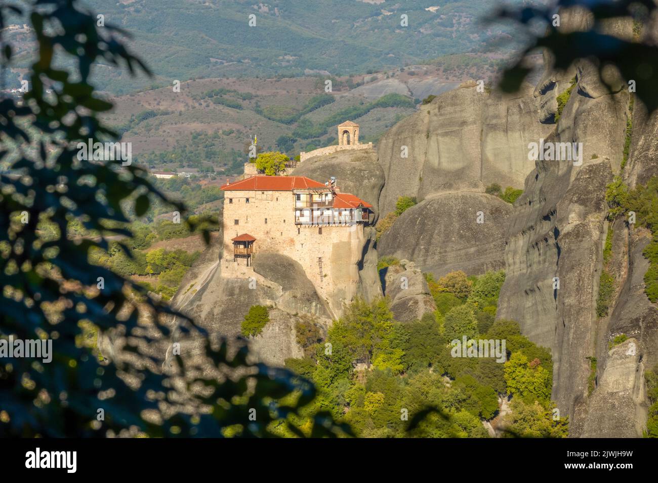 Summer Greece. Sunny day in Meteora. Convent on a high cliff surrounded ...