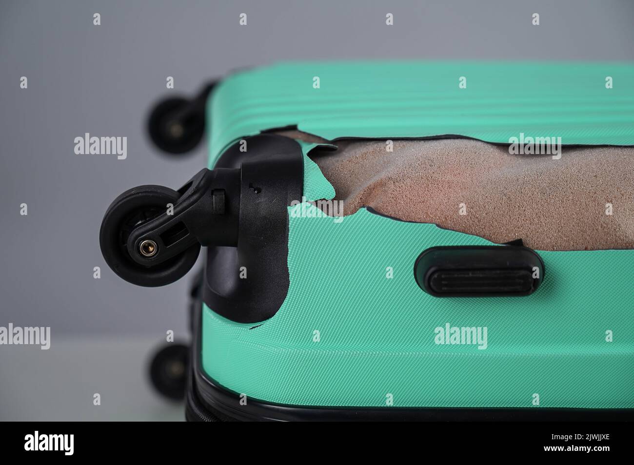 Mint damaged suitcase on a white background Stock Photo - Alamy