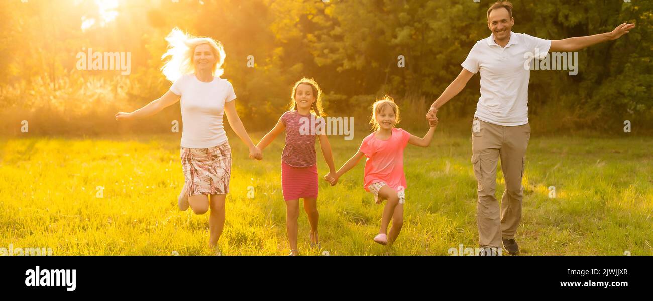 Happy family enjoying life together at meadow outdoor Stock Photo - Alamy