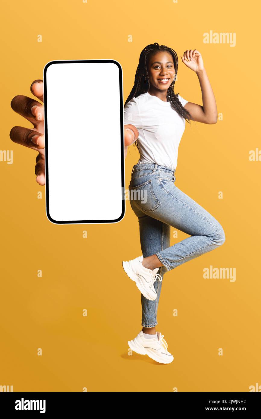 Lady showing huge smartphone hi-res stock photography and images - Alamy