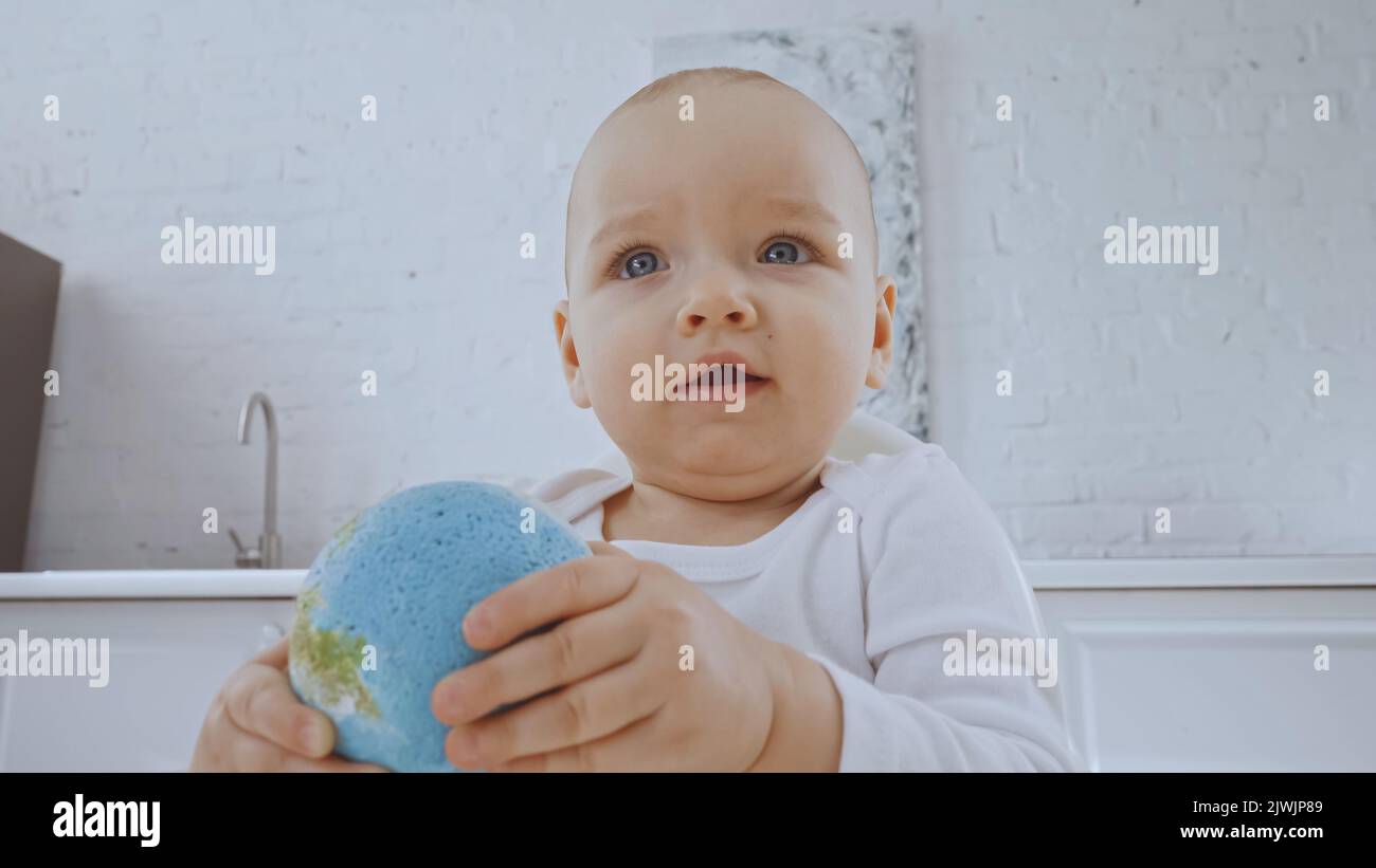 cute toddler girl with blue eyes holding small globe Stock Photo - Alamy