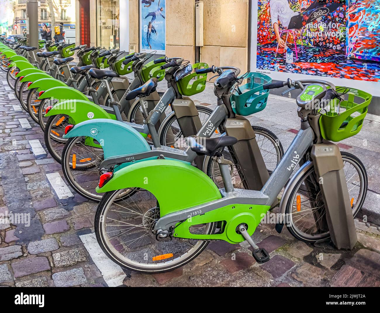 PARIS, FRANCE - FEBRUARY 17, 2020. Electric rental bikes, green and ...