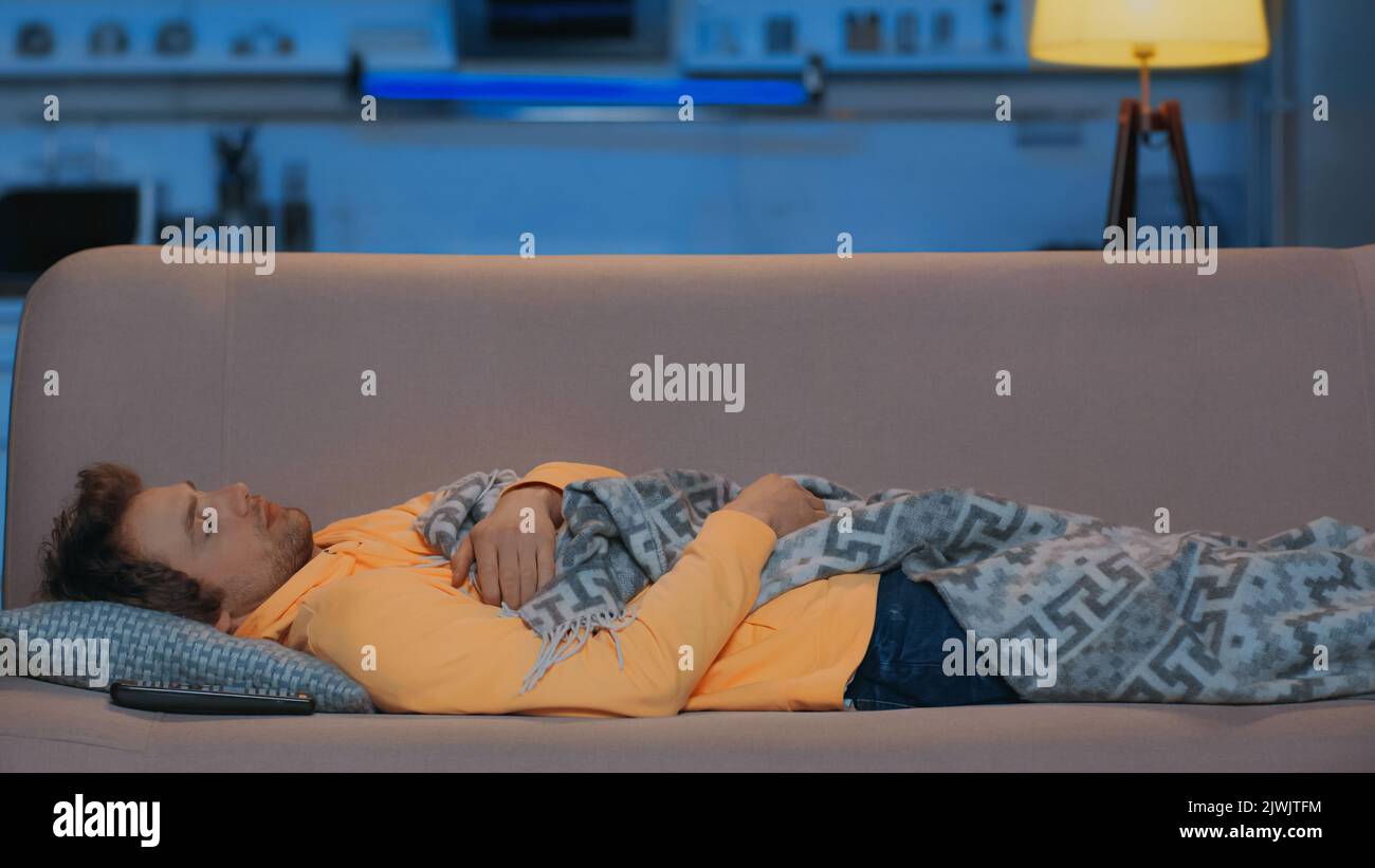 Man sofa sleeping blanket hi-res stock photography and images - Alamy