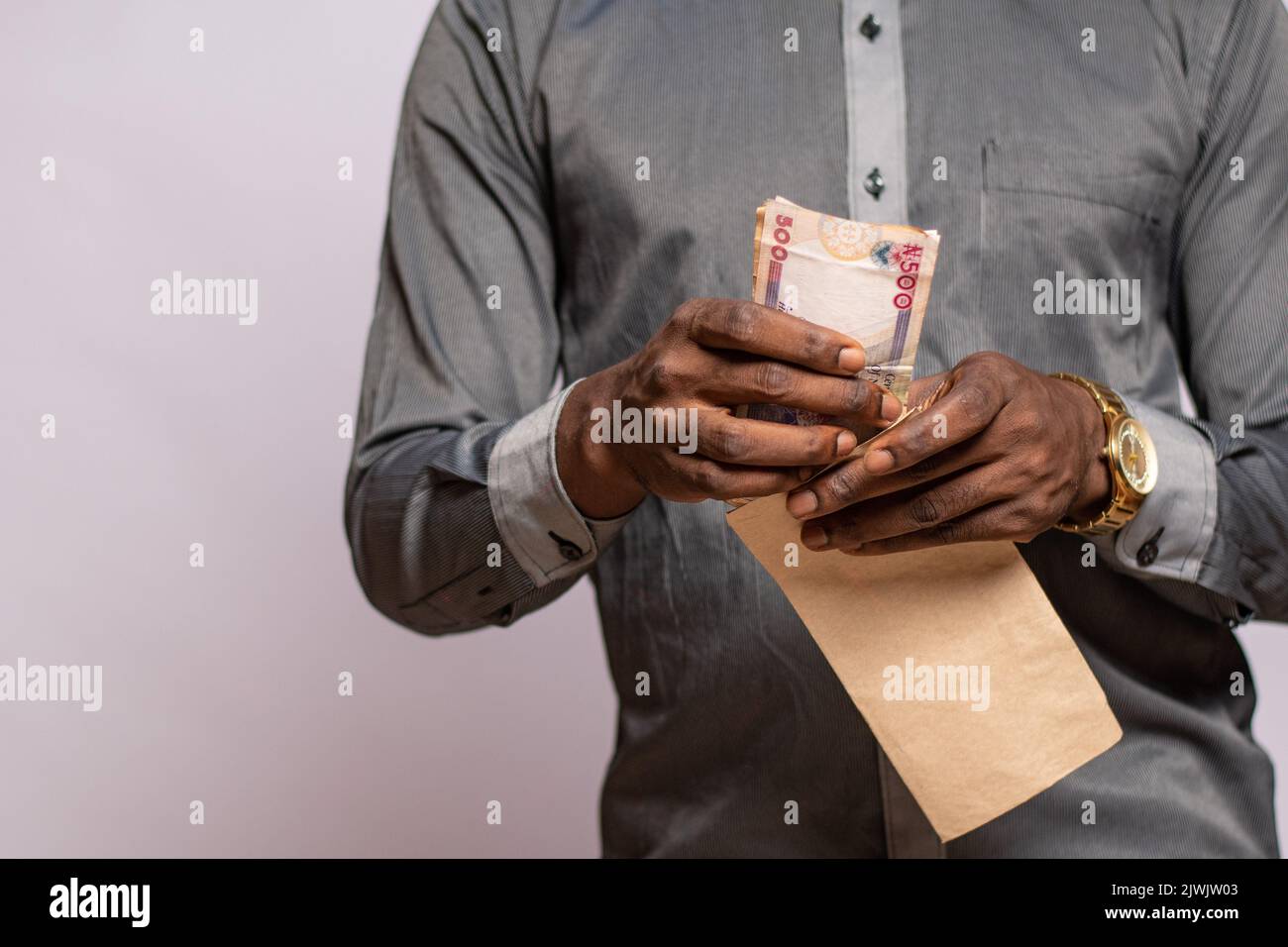 african man holding and envelope containing money Stock Photo - Alamy