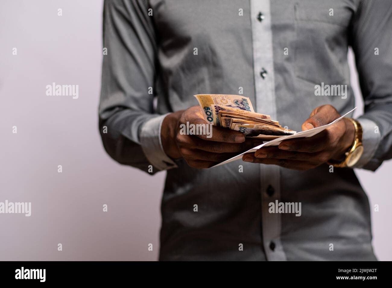 african man holding an envelope containing money Stock Photo - Alamy