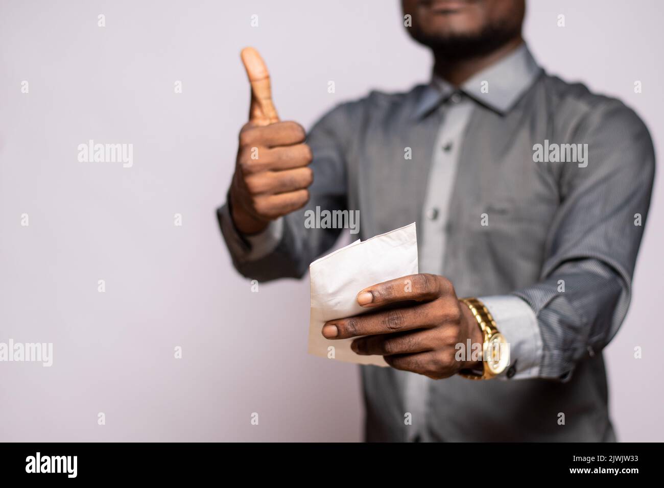 african man stretching an envelope forward, does thumbs up Stock Photo ...