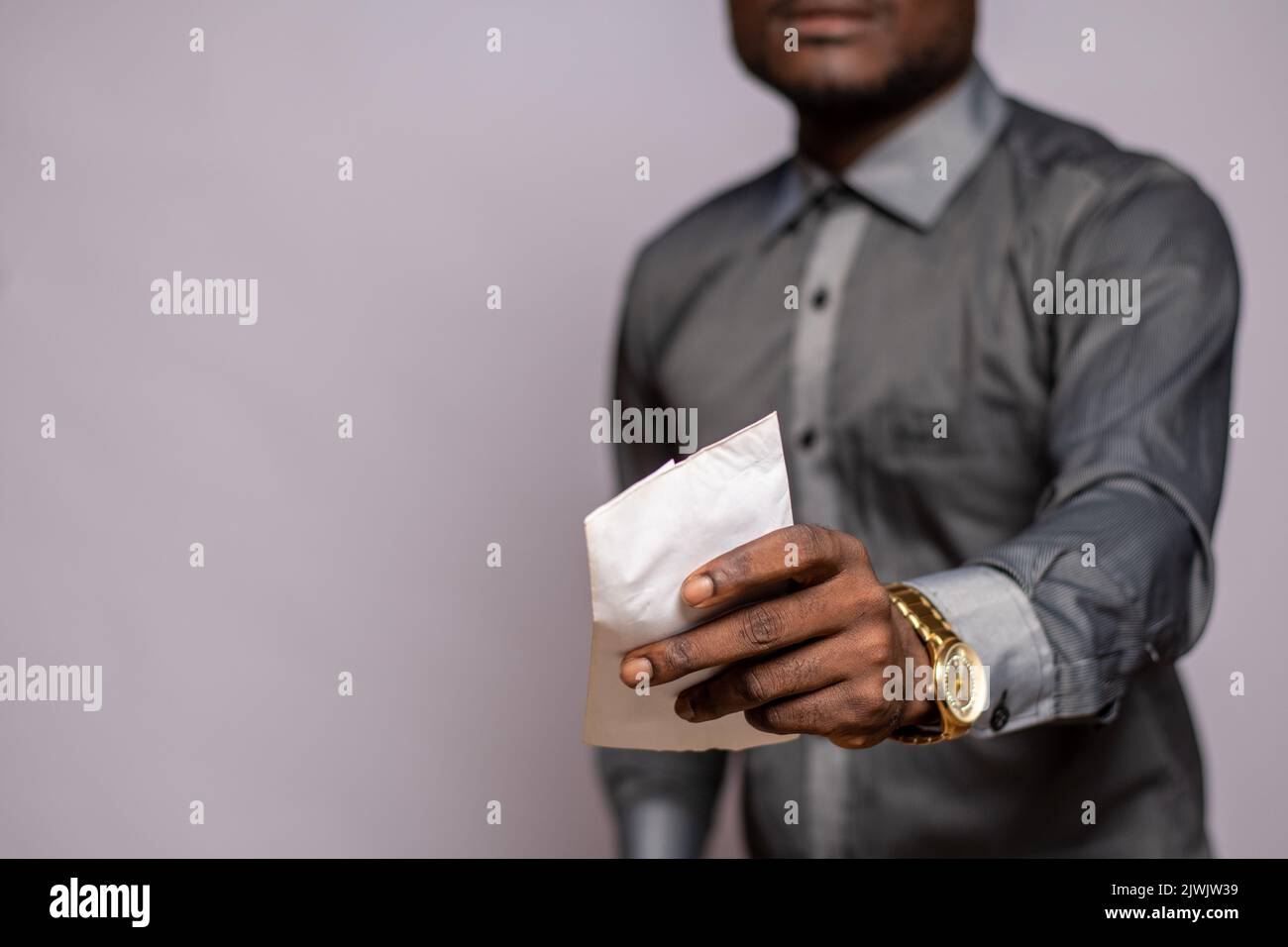 african man stretching an envelope forward Stock Photo - Alamy