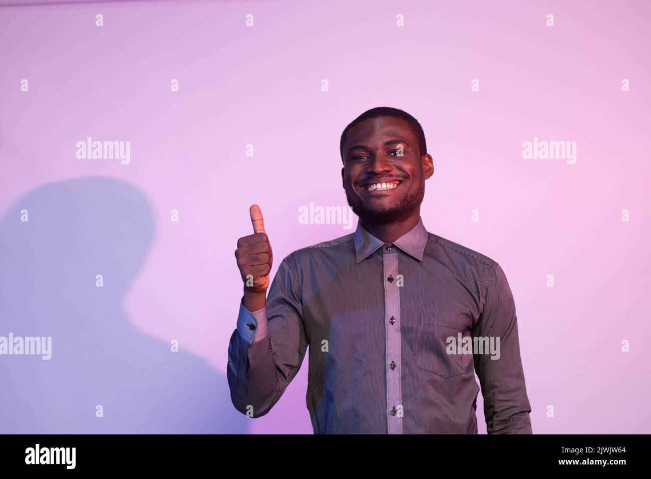 african man does thumbs up gesture Stock Photo - Alamy