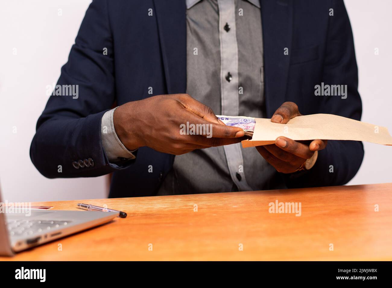 african businessman holding an envelope containing money Stock Photo ...