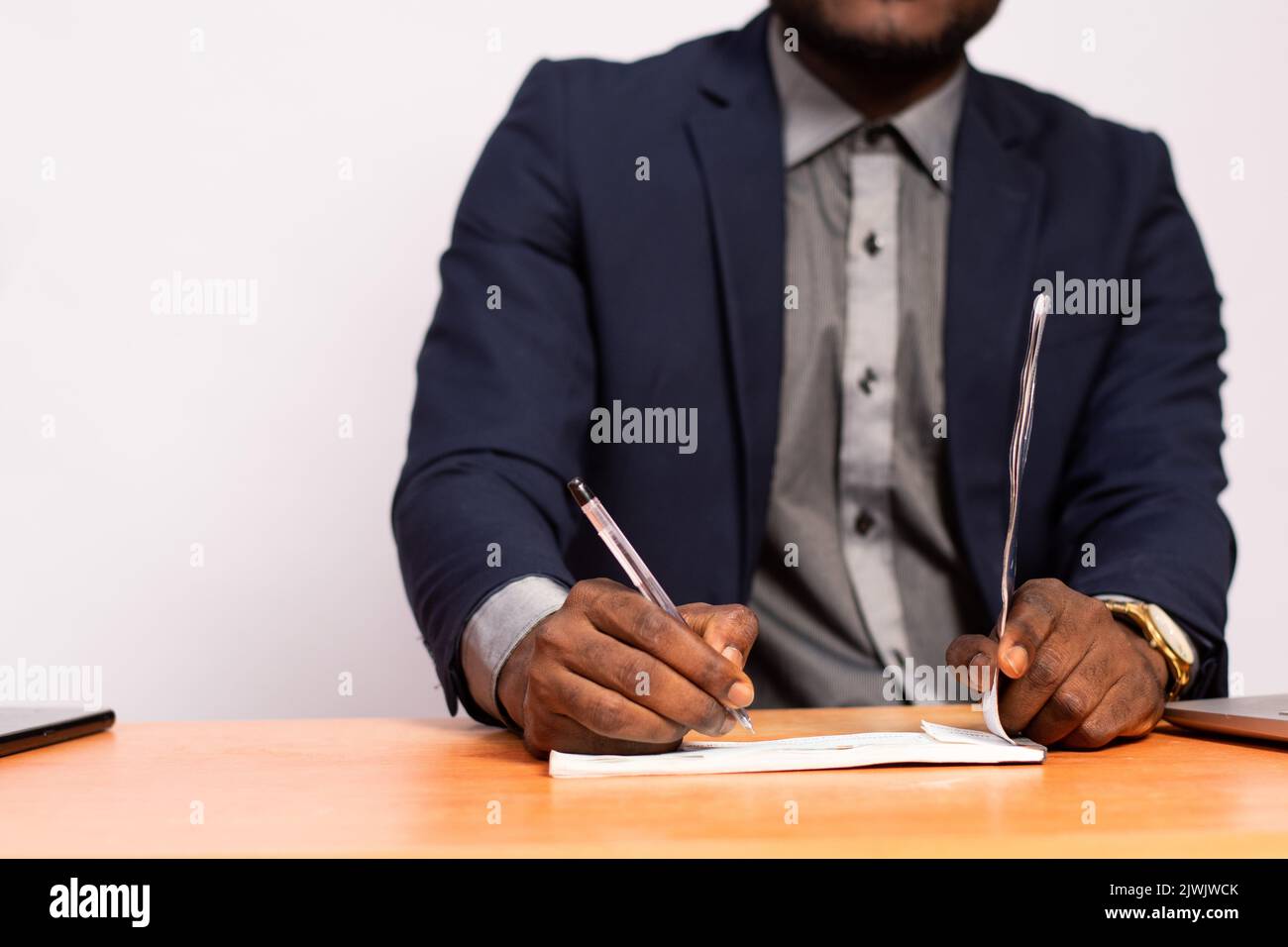 african businessman filling a check Stock Photo - Alamy