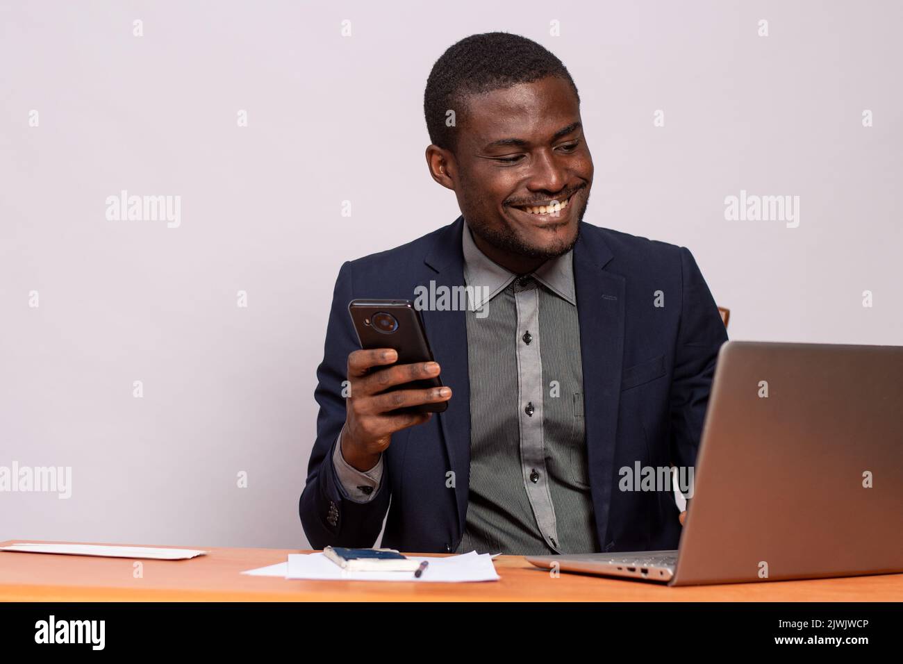 African businessman using smartphone laptop hi-res stock photography and images - Alamy