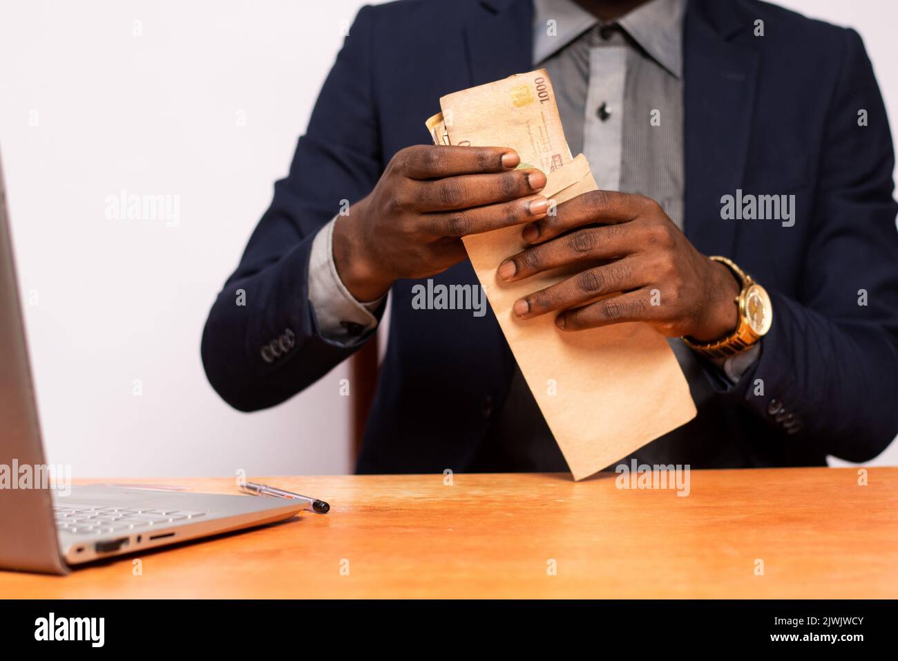 african businessman holding an envelope containing money Stock Photo ...