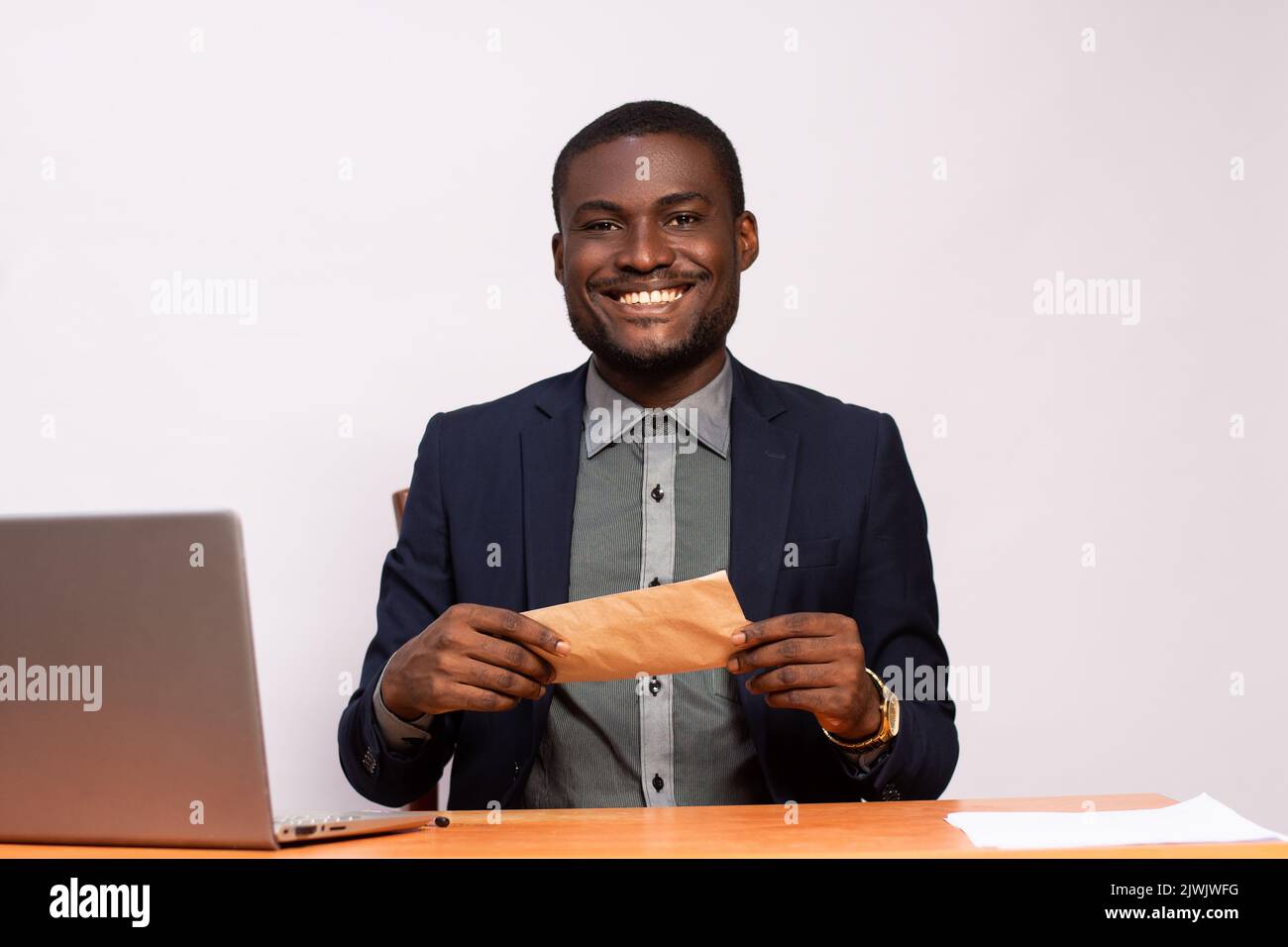 african businessman holding an envelope Stock Photo - Alamy