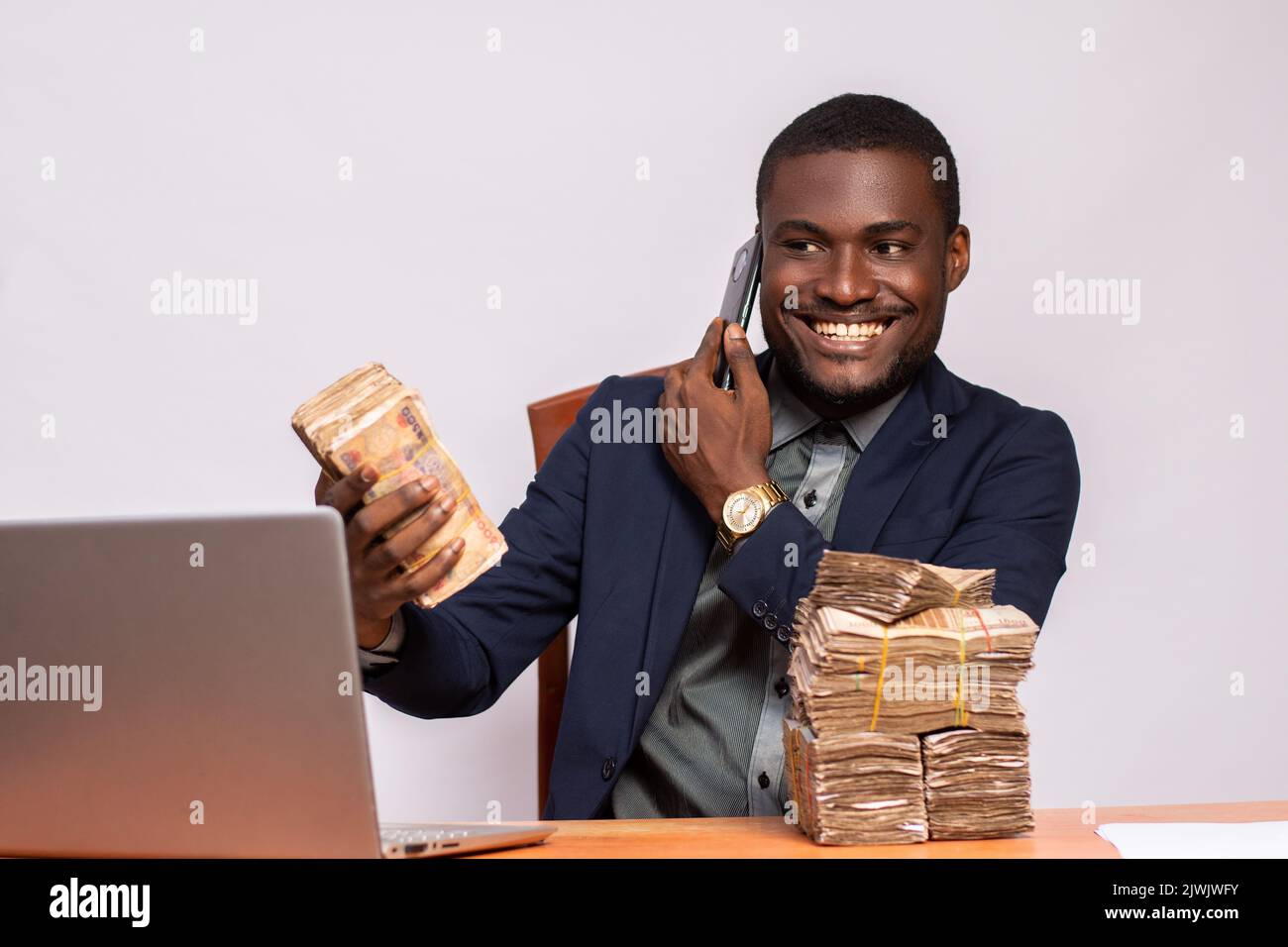 excited african businessman with lots of money making phone call Stock ...