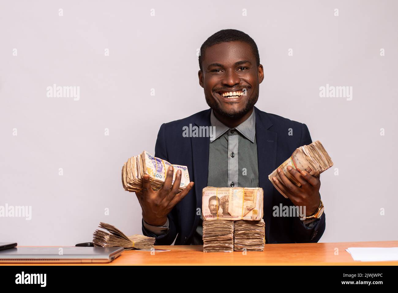 happy african businessman with lots of money Stock Photo - Alamy