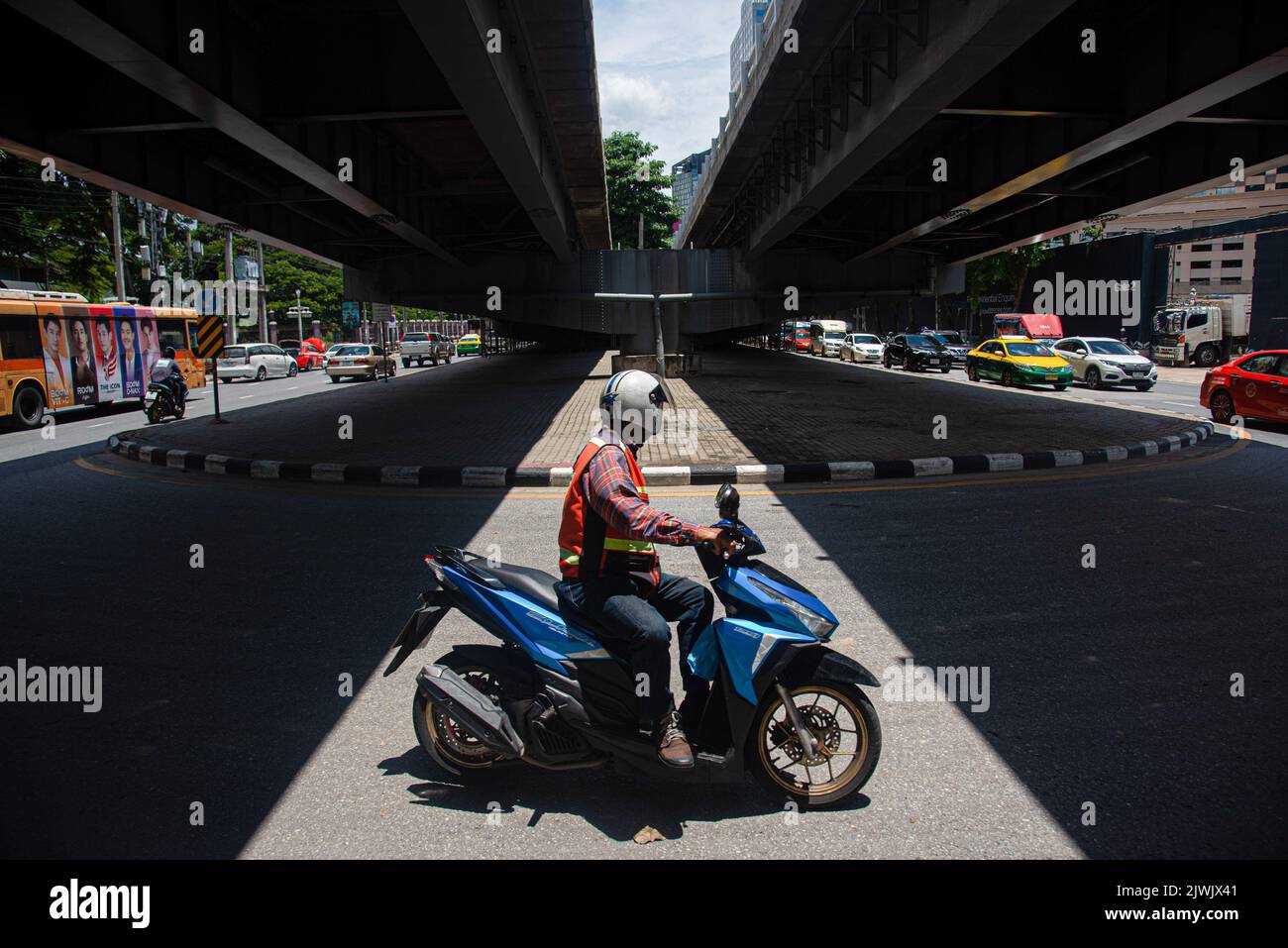A motorcyclist rides along the road at Sala Daeng intersection in Bangkok. (Photo by Peerapon ...