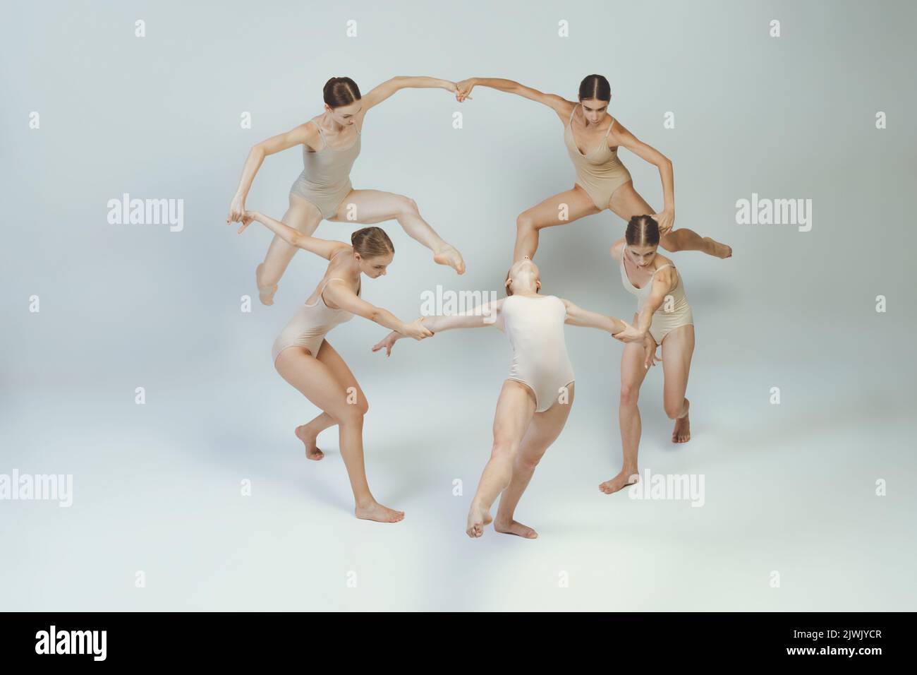 Group of young girls, ballet dancers performing, posing isolated over ...