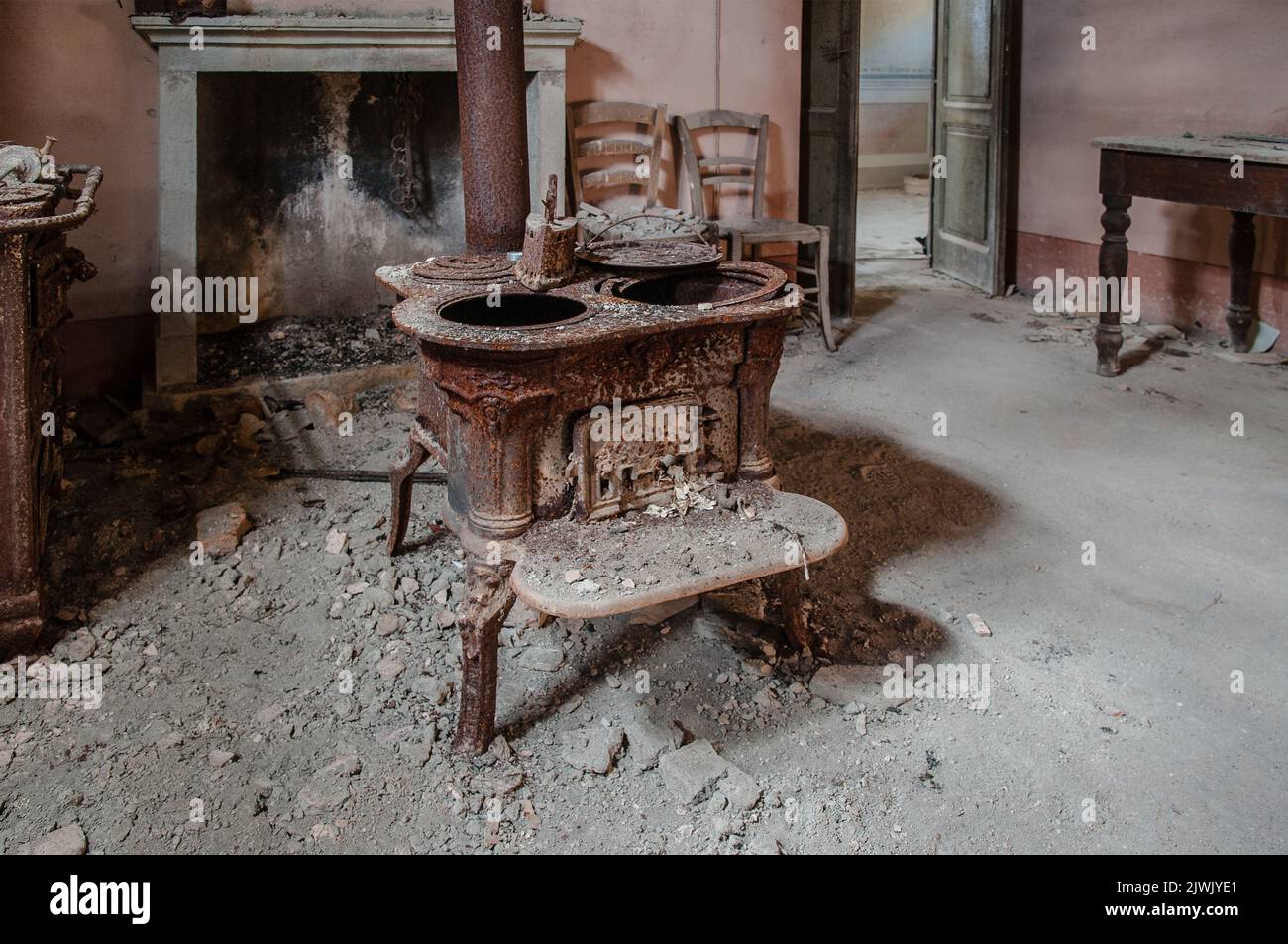 September 2022, Italy. Urbex old rusty cast iron stove in an abandoned ...