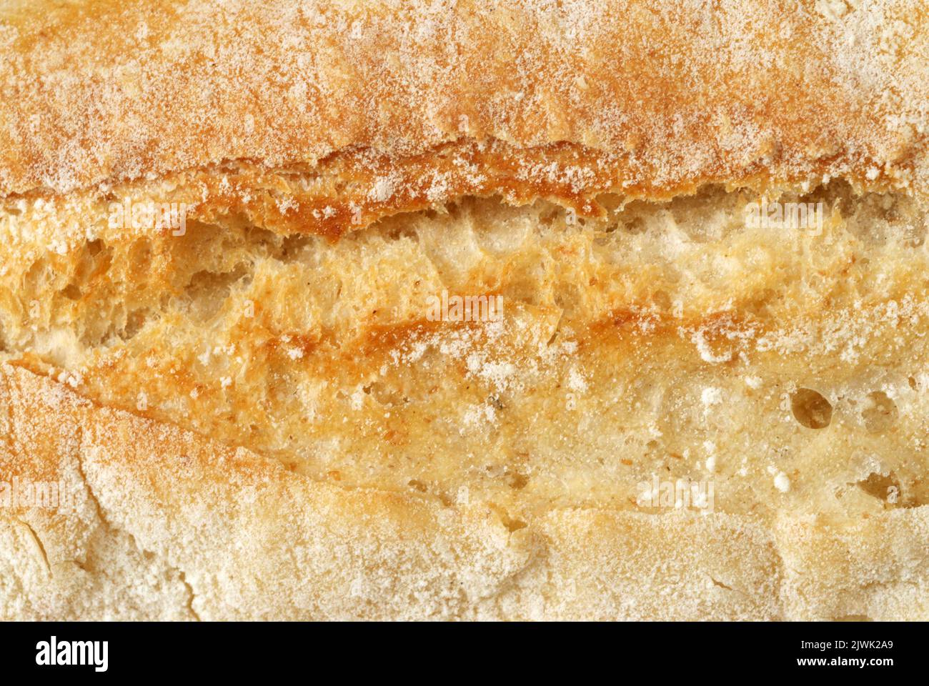 close up of a piece of fresh baked crusty white bread full frame ...