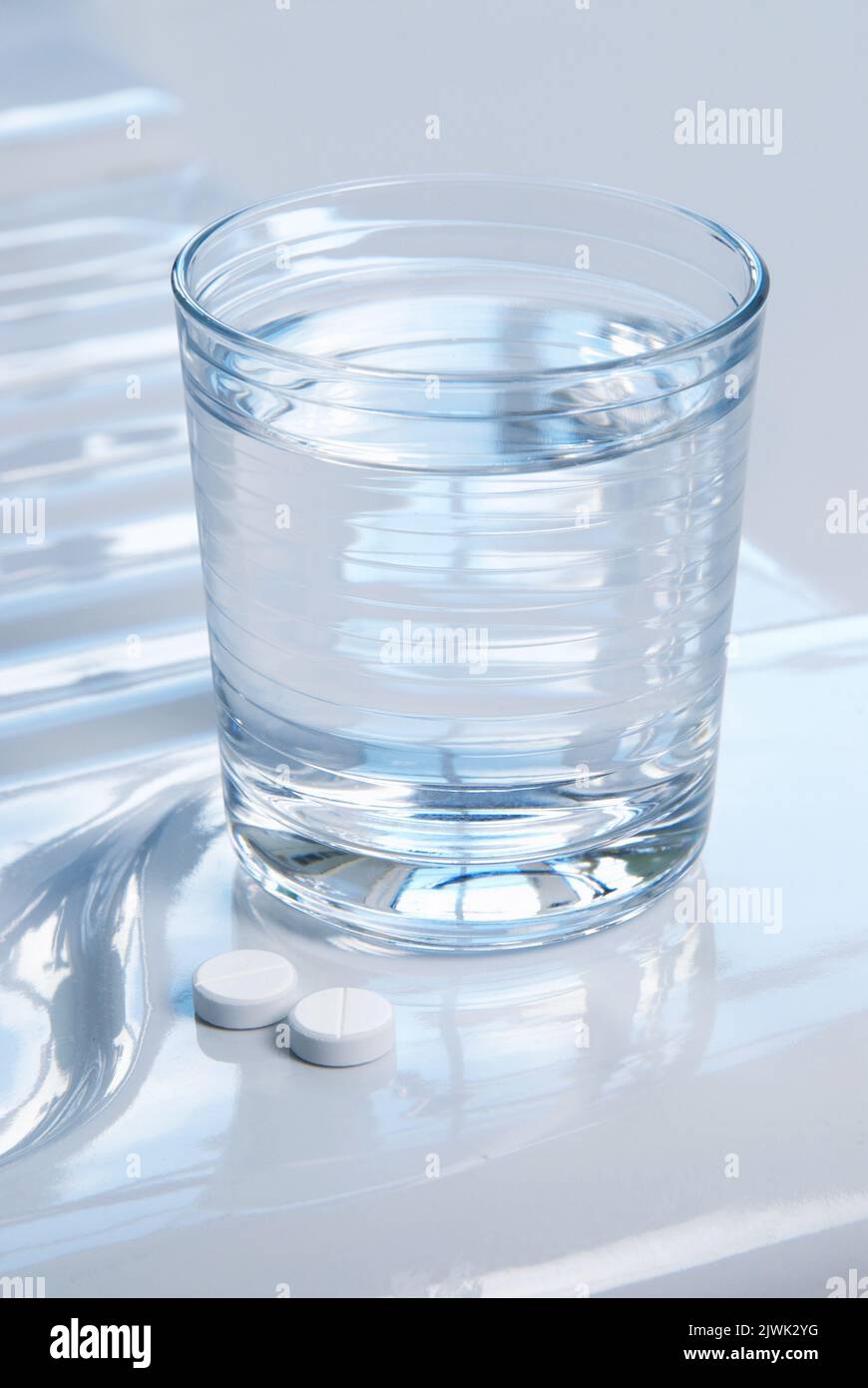 A glass of water and two tablets at the side of the sink Stock Photo ...