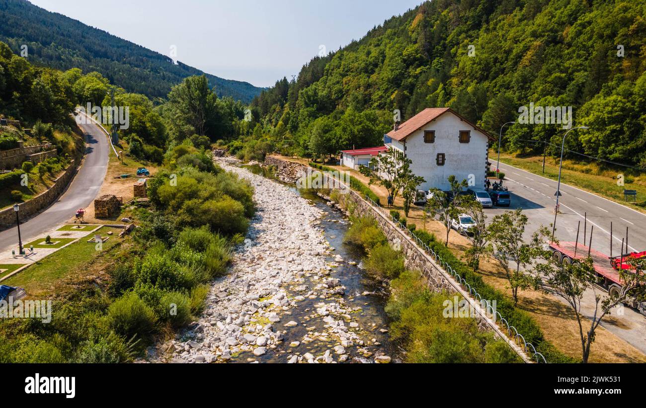 Drone view of the town of Urzainqui, by the river in Valle del Roncal ...