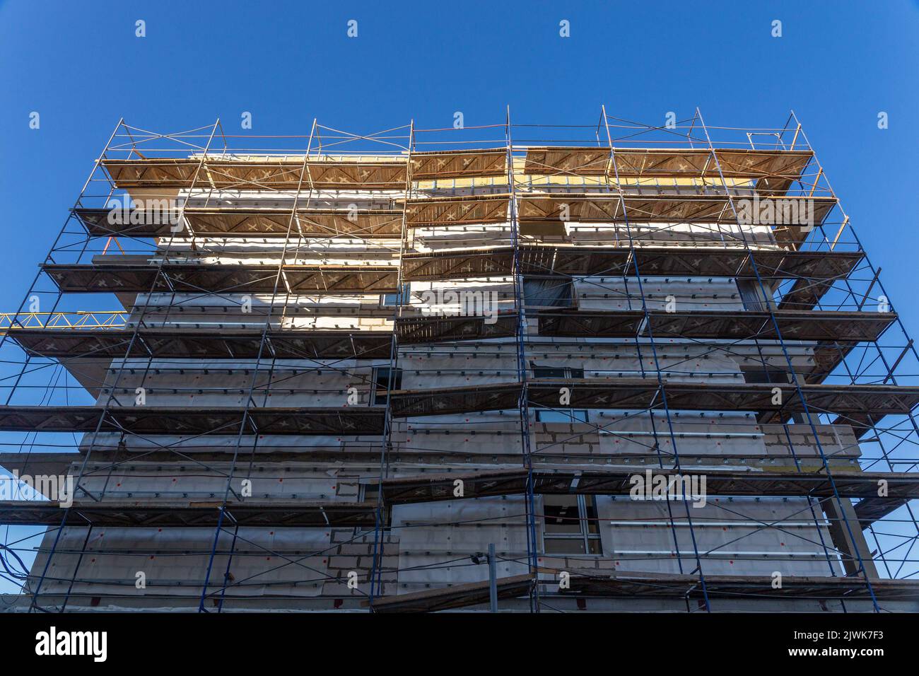 Insulation of the exterior walls of a building under construction. The ...