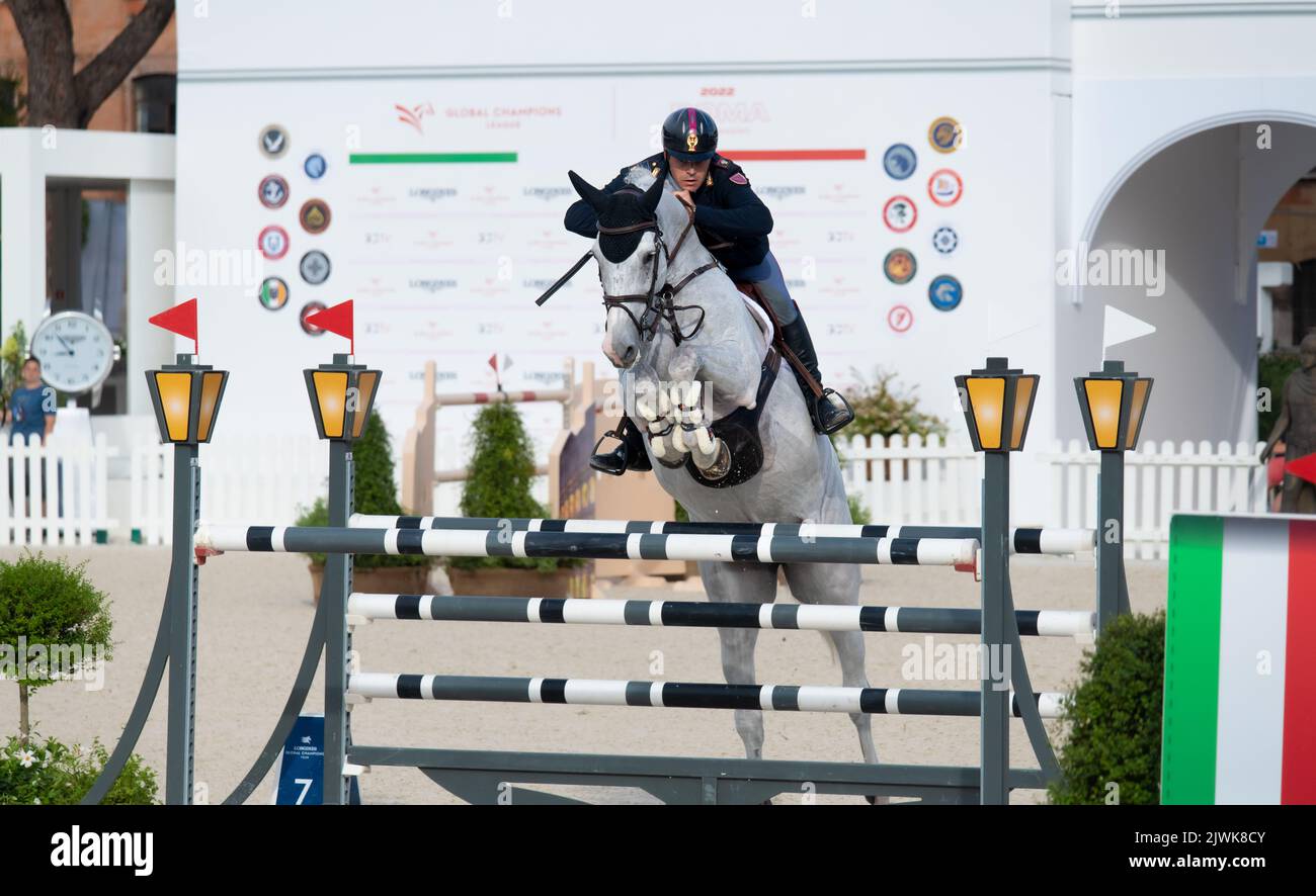 Man riding horse and jumping during equestrian competition, Italy, 2-4 ...