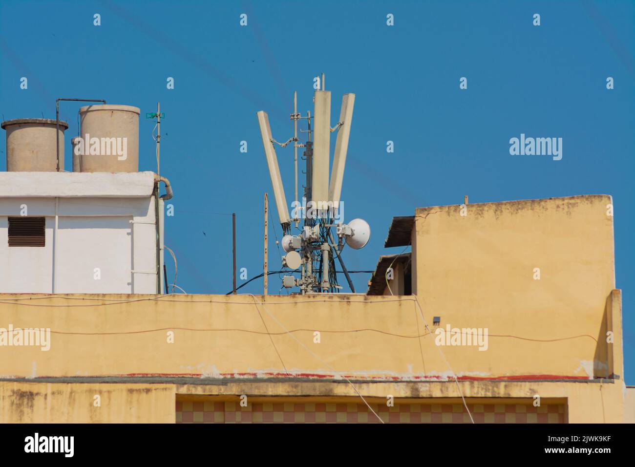 Tower with wifi network antennas, on the roof of a residential building ...