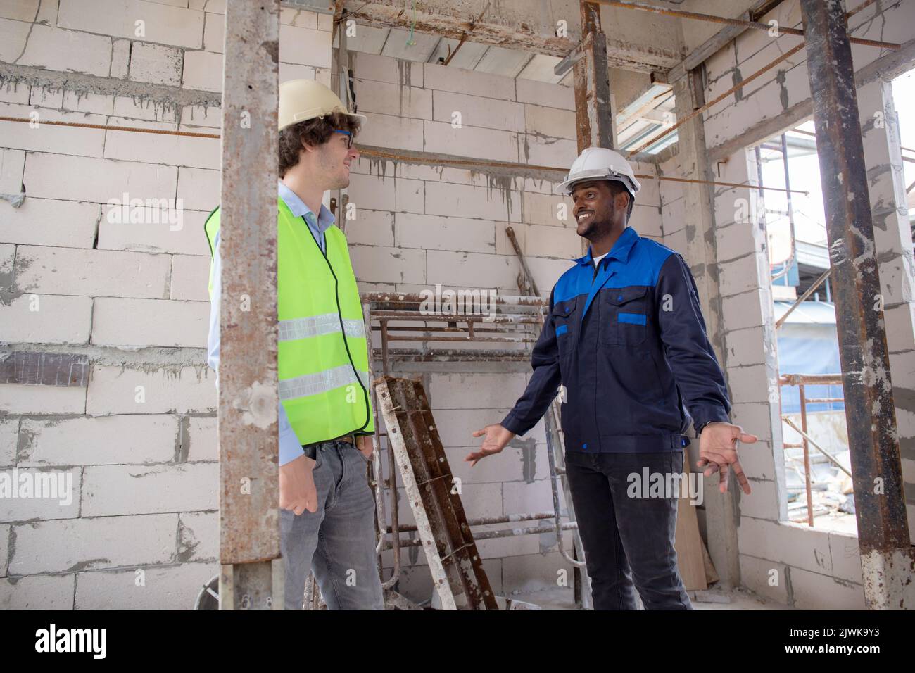 Architect and builder talking and inspector construction at ...