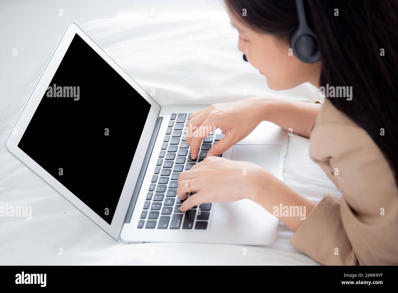 Young asian woman work from home with laptop computer blank screen mockup, freelance is female ...