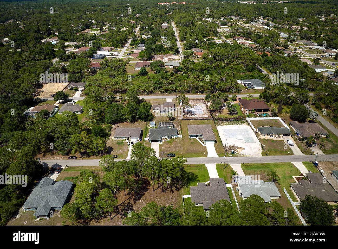 Aerial landscape view of suburban private houses between green palm ...
