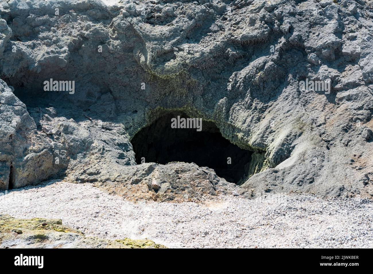 vent of a volcanic fumarole in the ground, covered with crystalline ...