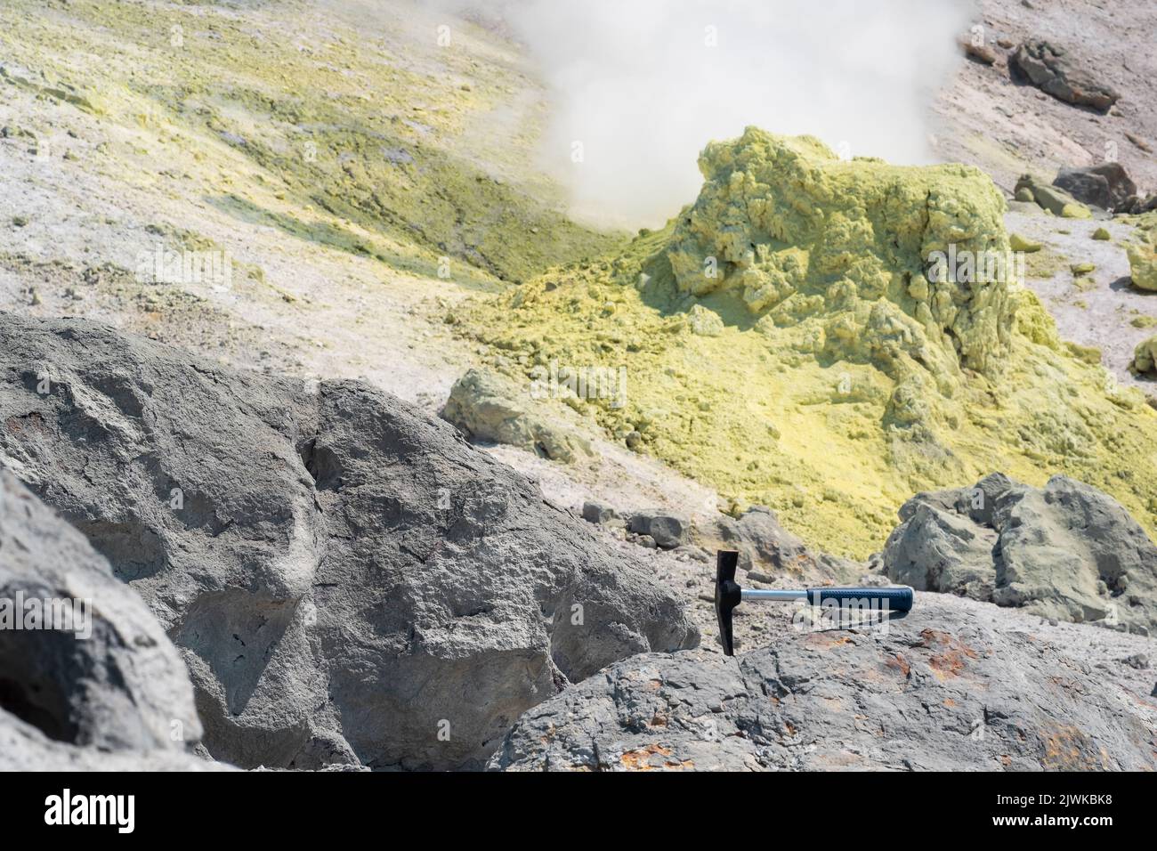 geological hammer in the rock against the backdrop of an steaming ...