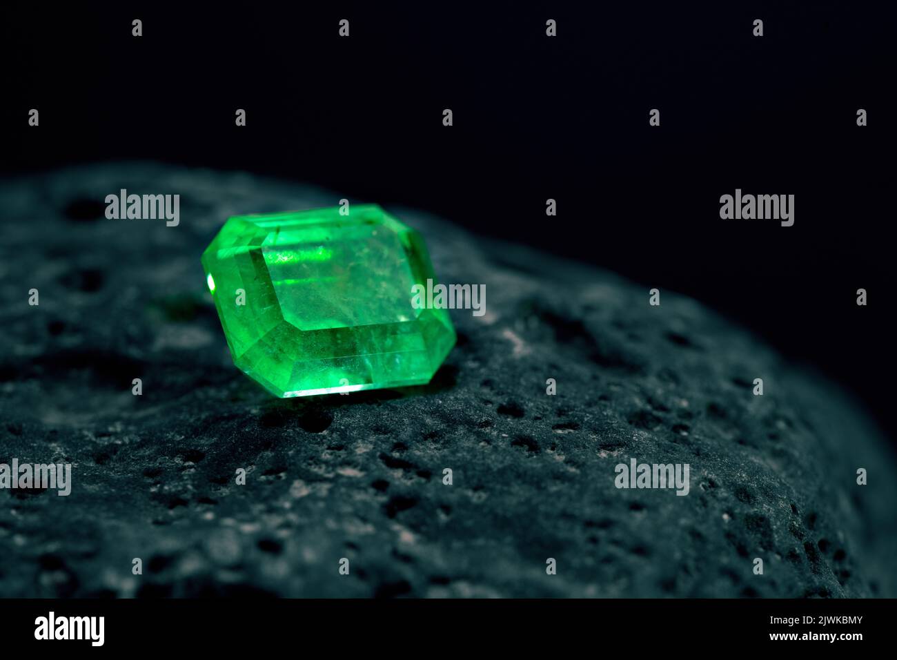 Natural Green Emerald Stone on Dark Stone Stock Photo - Alamy