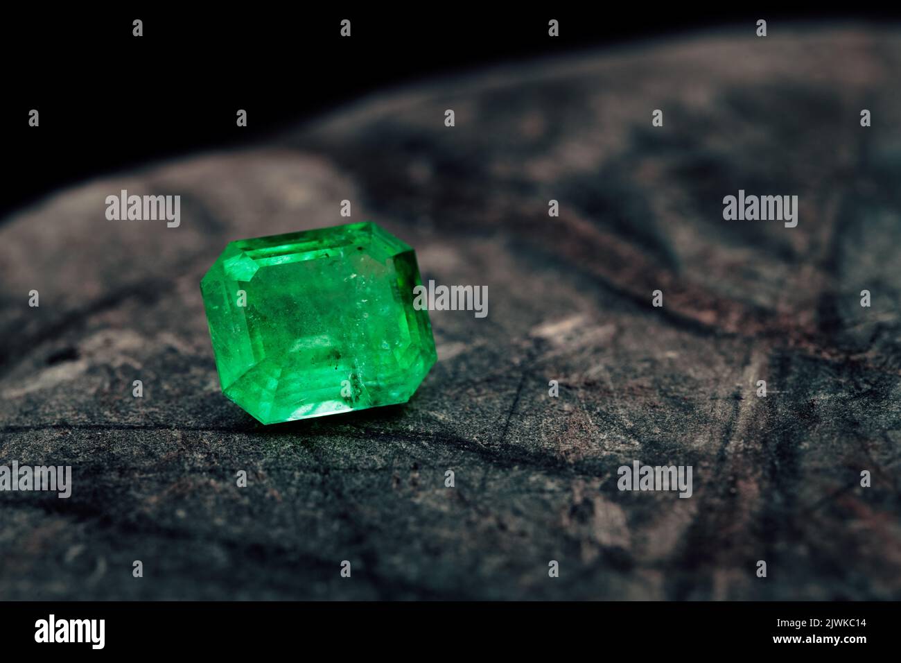 Natural Green Emerald Stone on Dark Stone Stock Photo - Alamy