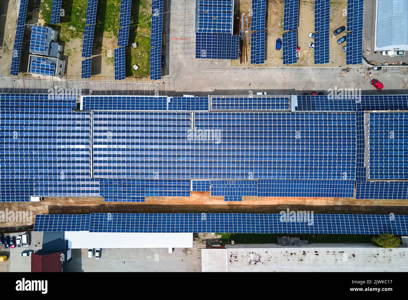 Aerial view of blue photovoltaic solar panels mounted on industrial ...