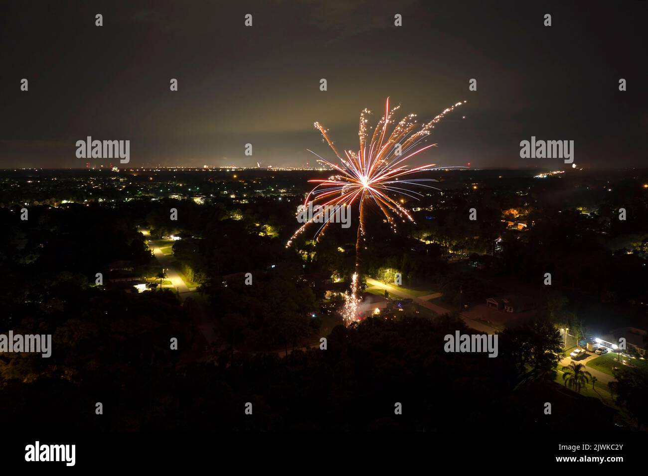 Aerial view of bright fireworks exploding with colorful lights over ...