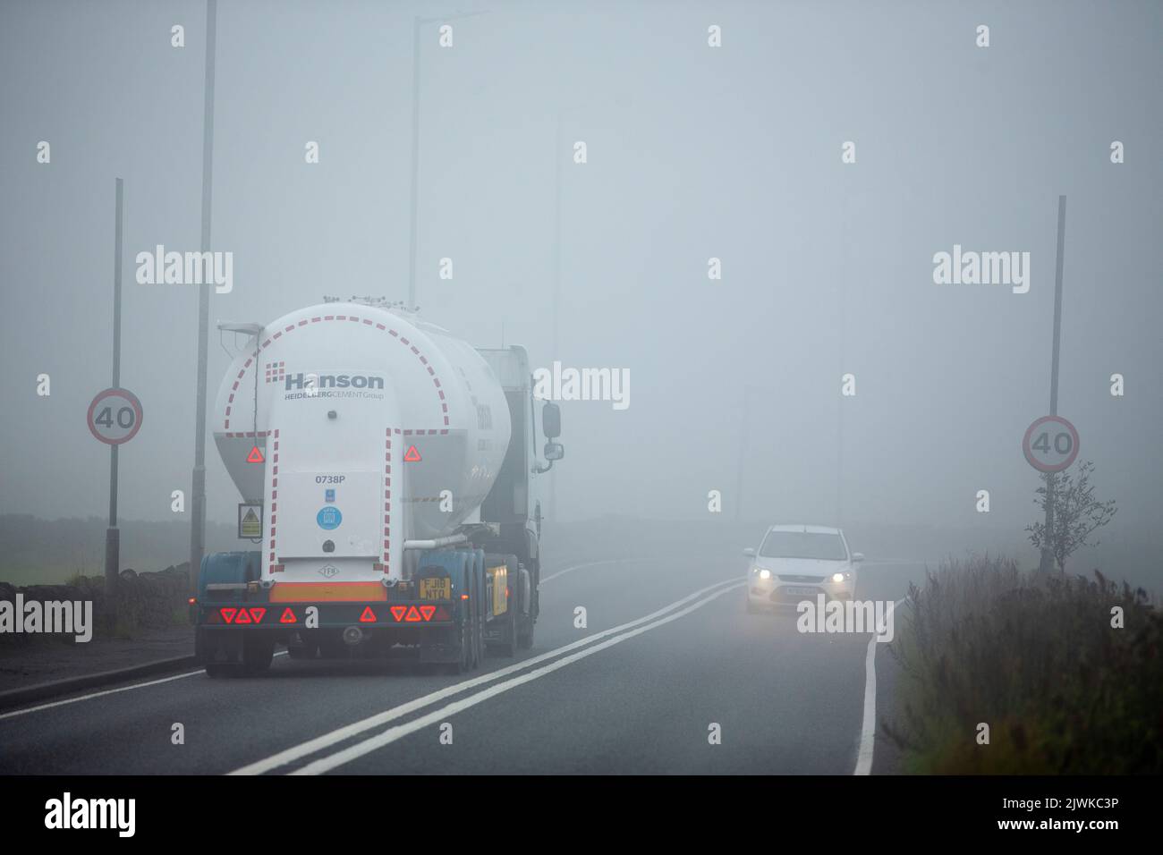 Car, van and lorry drivers with headlights on drive past a 40 mph ...