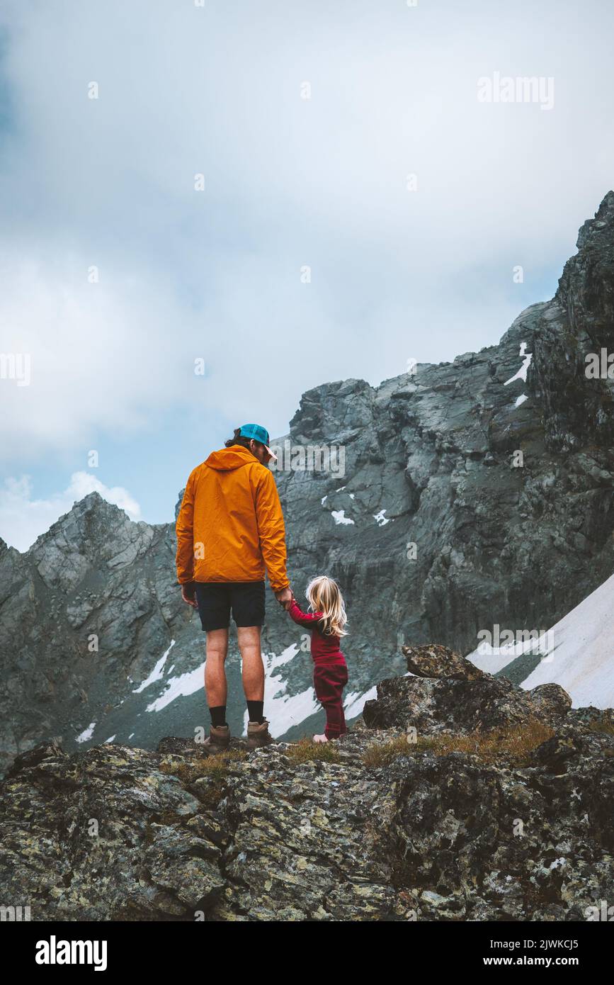 Father and child trekking in mountains family travel adventure ...