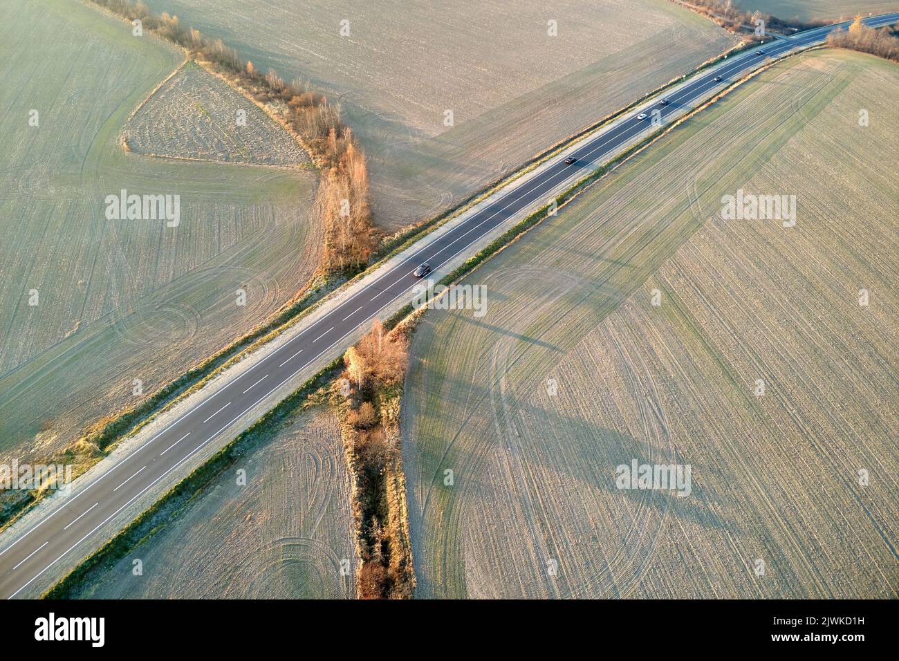 Aerial view of intercity road with fast driving cars at sunset. Top ...