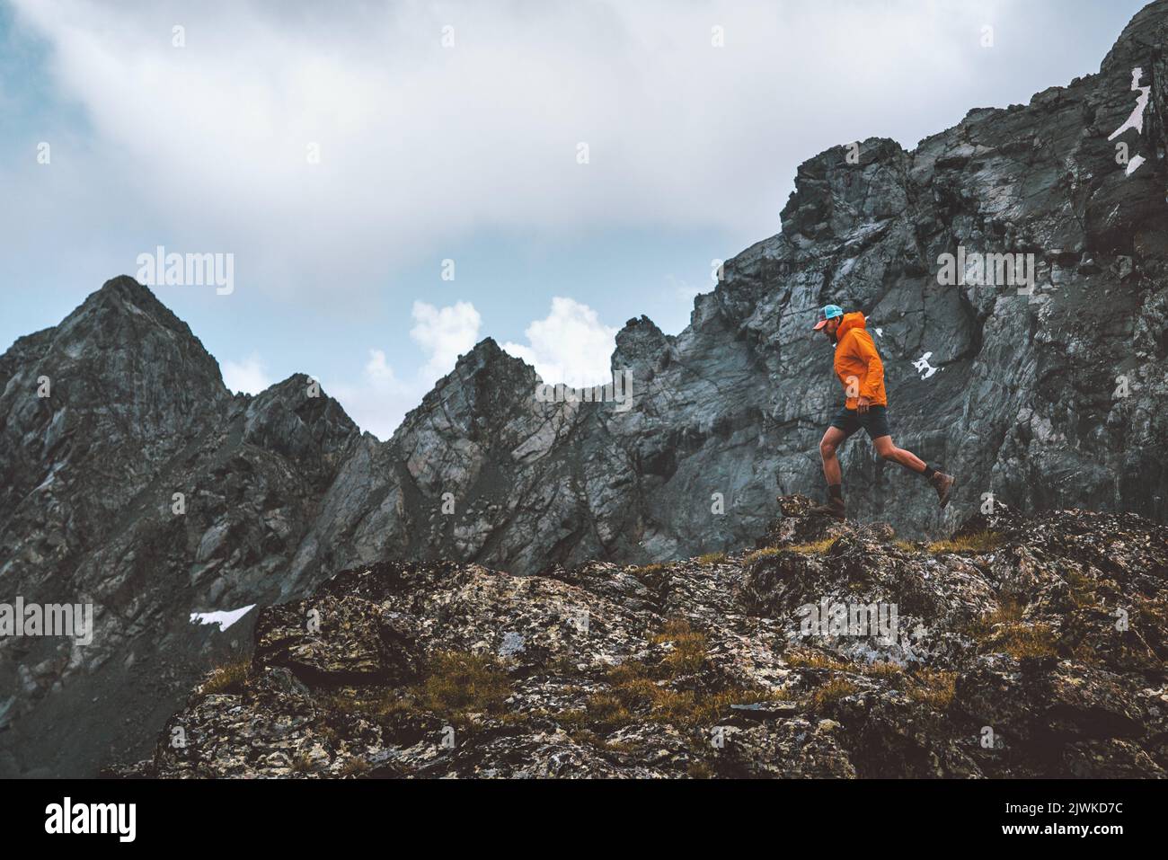 Active man trail running in rocky mountains extreme travel energy ...