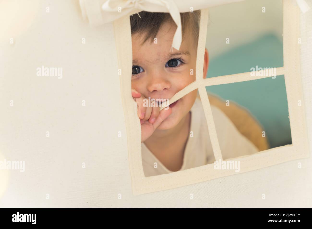 Closeup shot of an adorable brown-haired caucasian preschooler boy ...