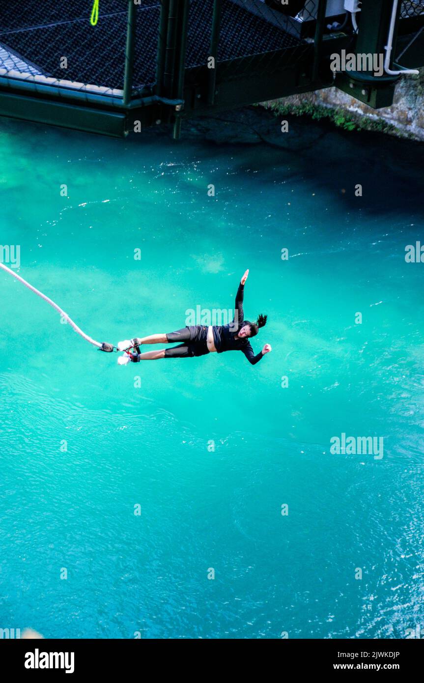 A bungy jumper connected with an elastic cord, plunges 47 metres below ...