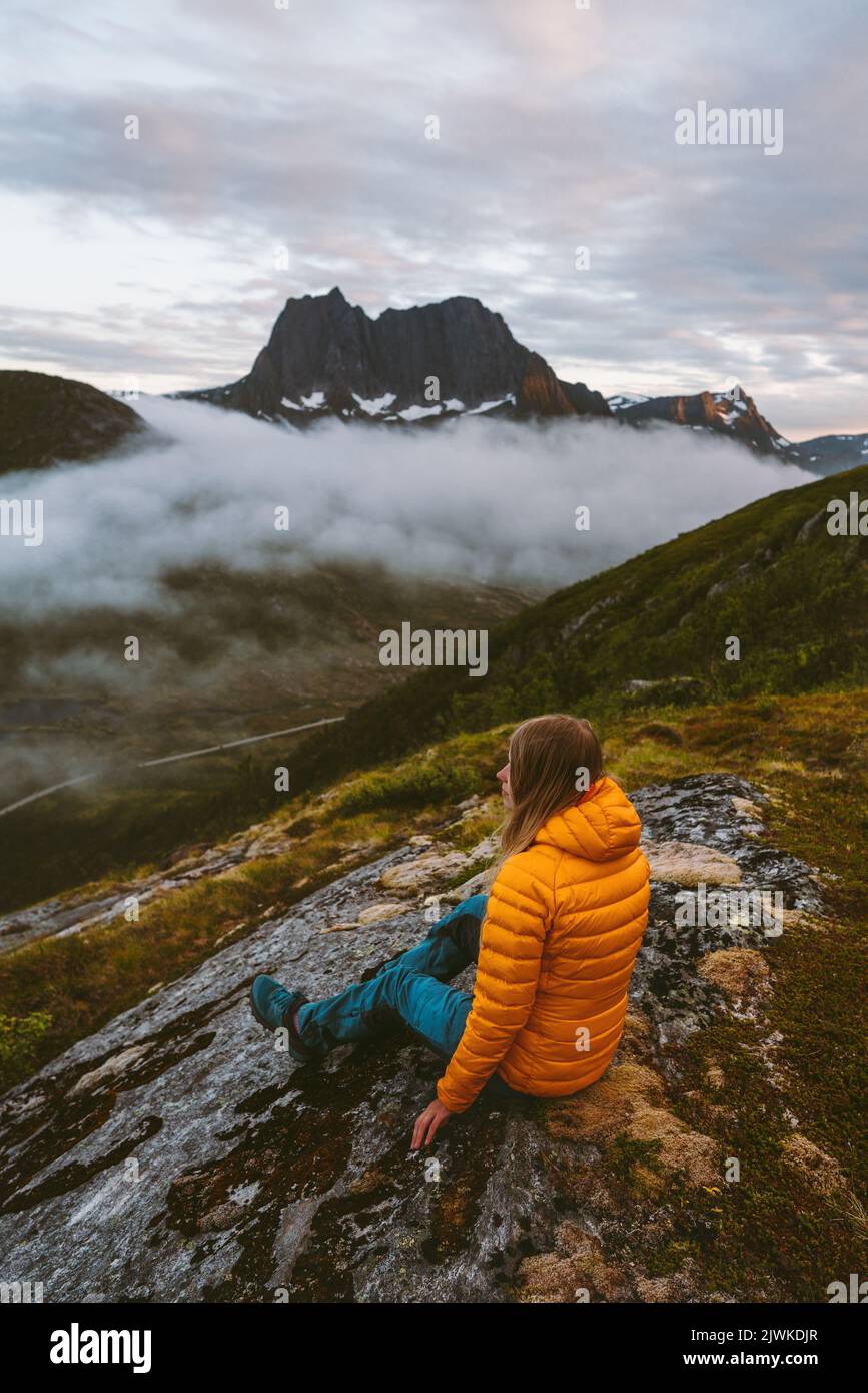 Traveler woman hiker sitting on cliff hiking in mountains outdoor ...